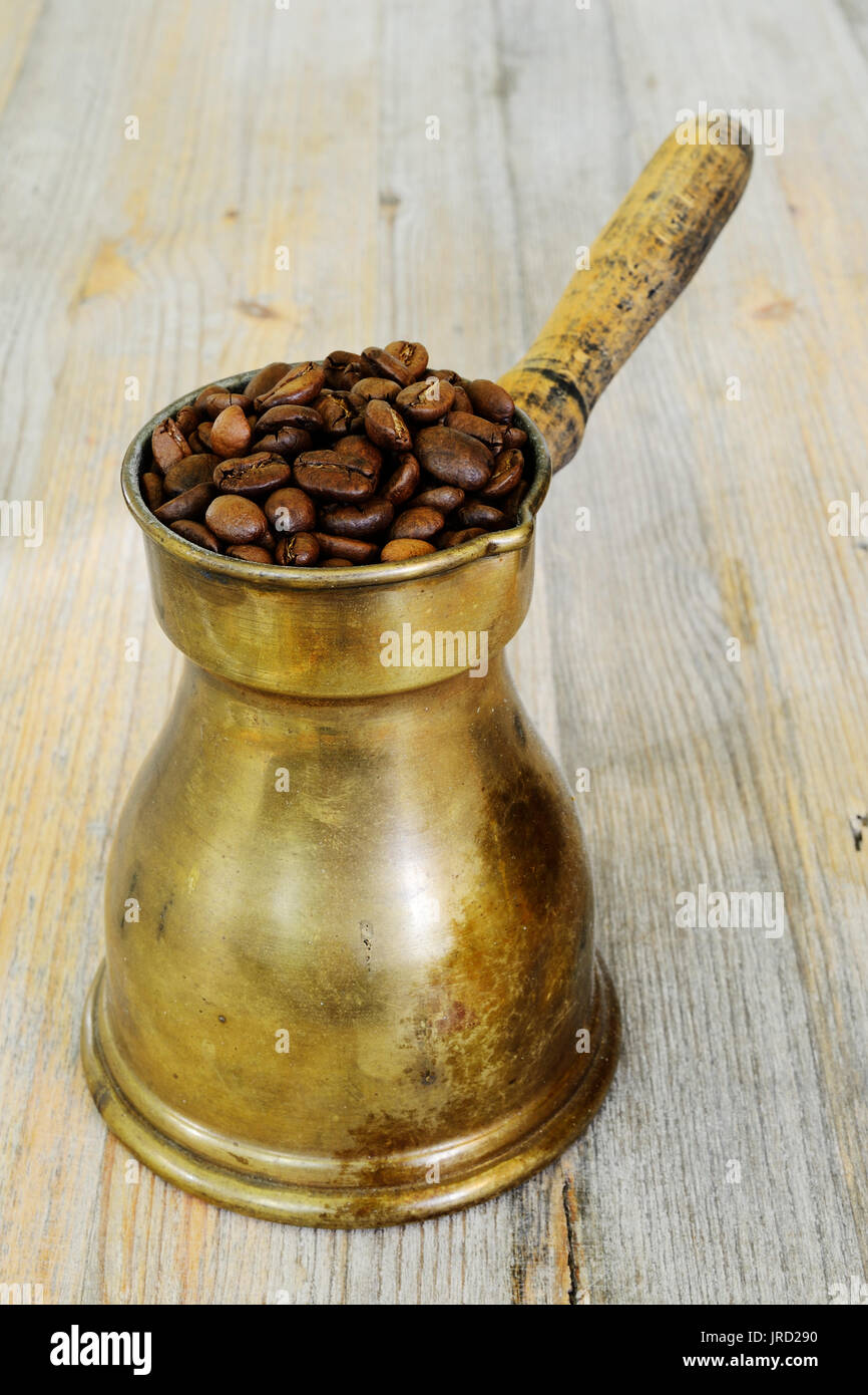 old arabic coffee pot on wooden background with beans Stock Photo - Alamy