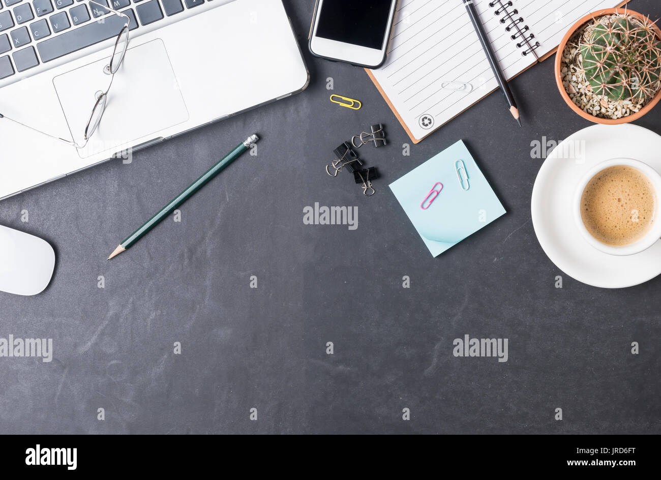 Office black desk table with computer, smartphone, paper note, supplies ...