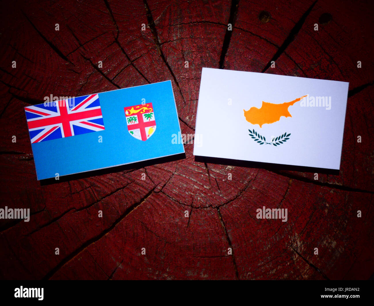 Fijian flag with Cypriot flag on a tree stump isolated Stock Photo - Alamy