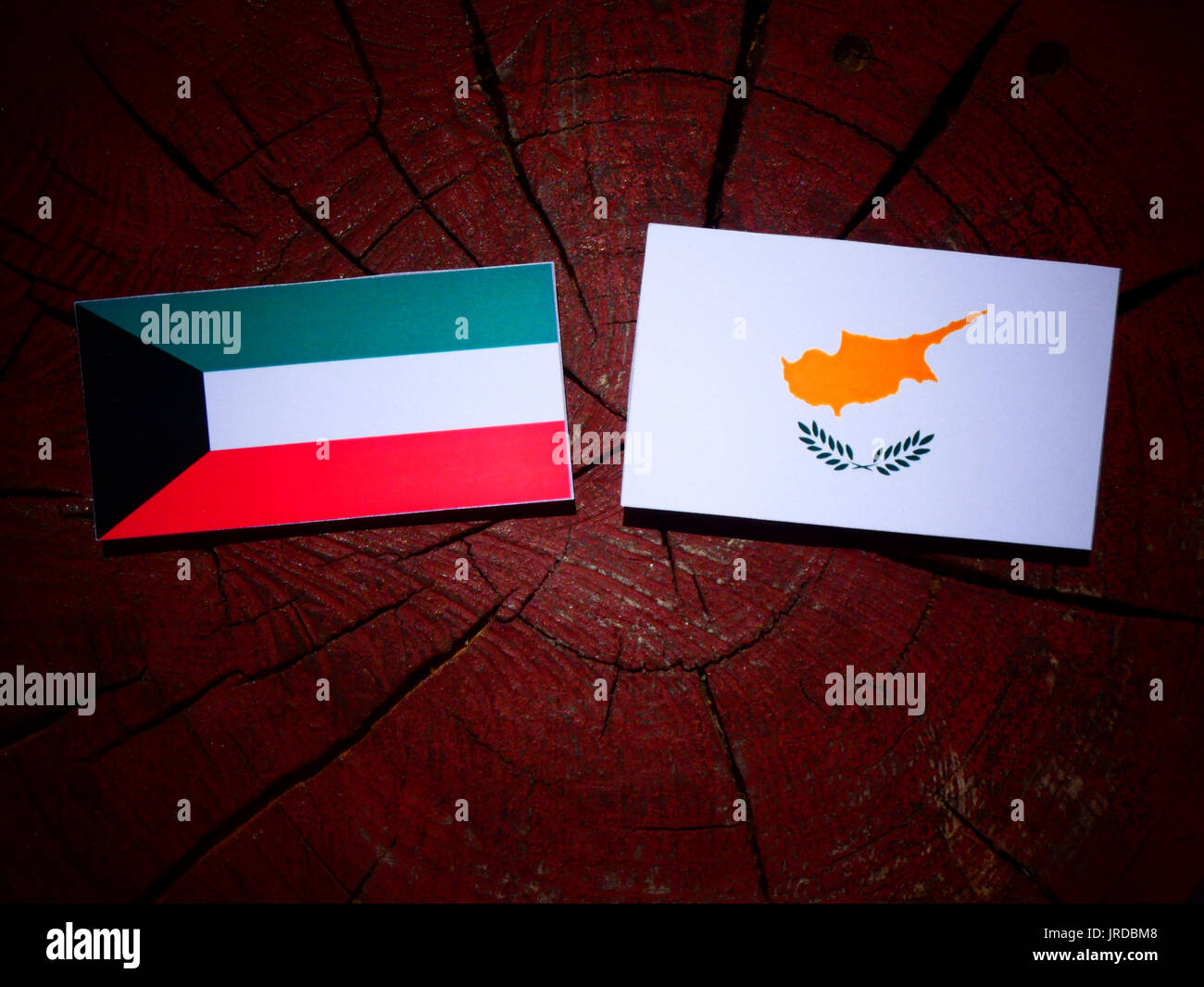 Kuwaiti flag with Cypriot flag on a tree stump isolated Stock Photo - Alamy