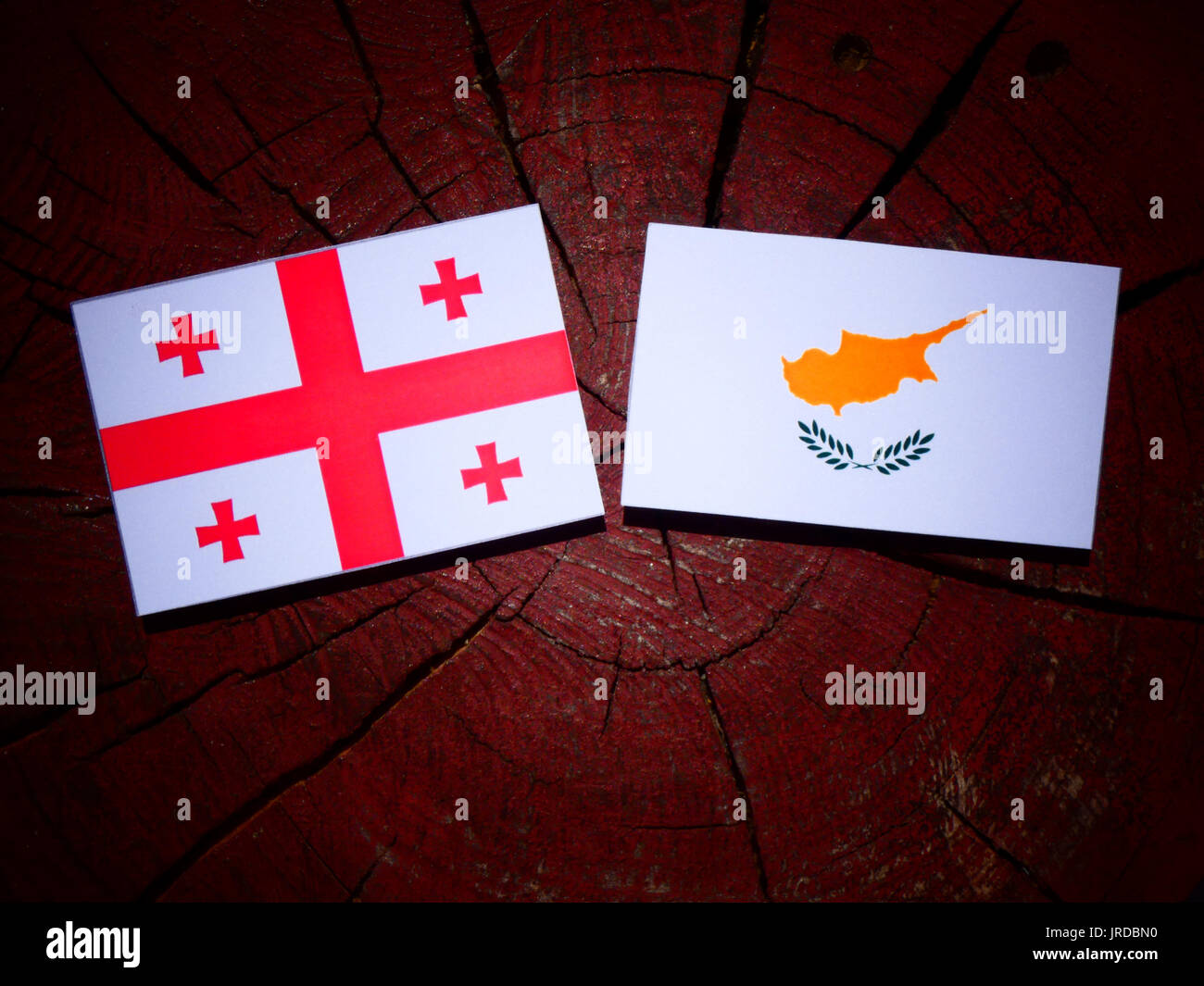 Georgian flag with Cypriot flag on a tree stump isolated Stock Photo ...