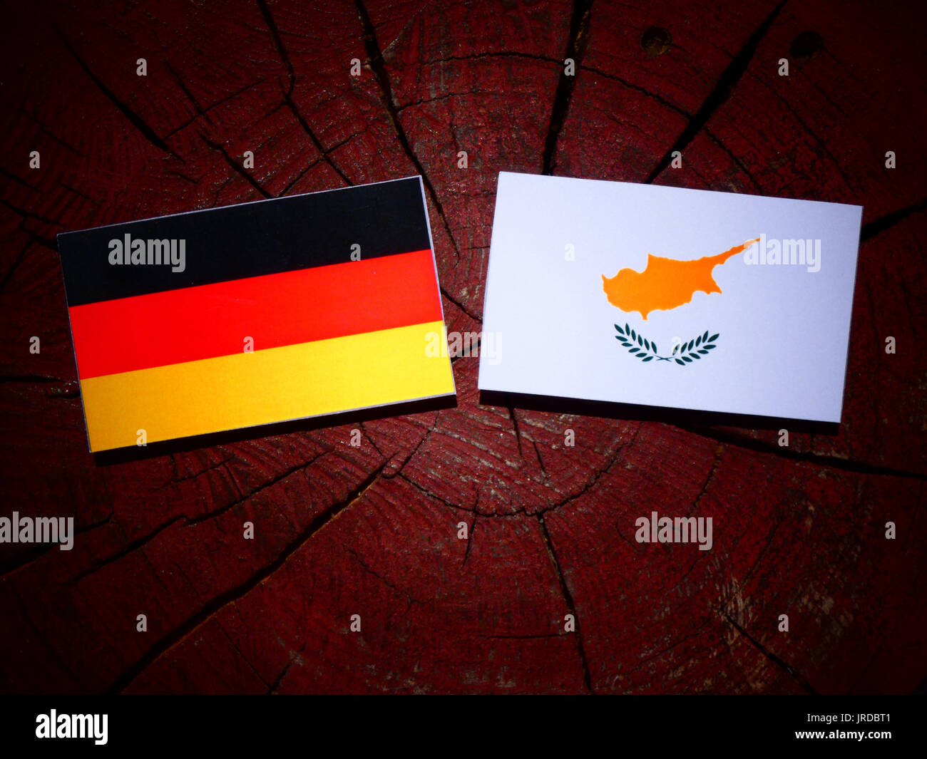 German flag with Cypriot flag on a tree stump isolated Stock Photo - Alamy