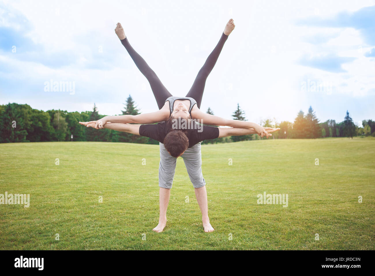 Strong acrobatic woman lifting man hi-res stock photography and images ...