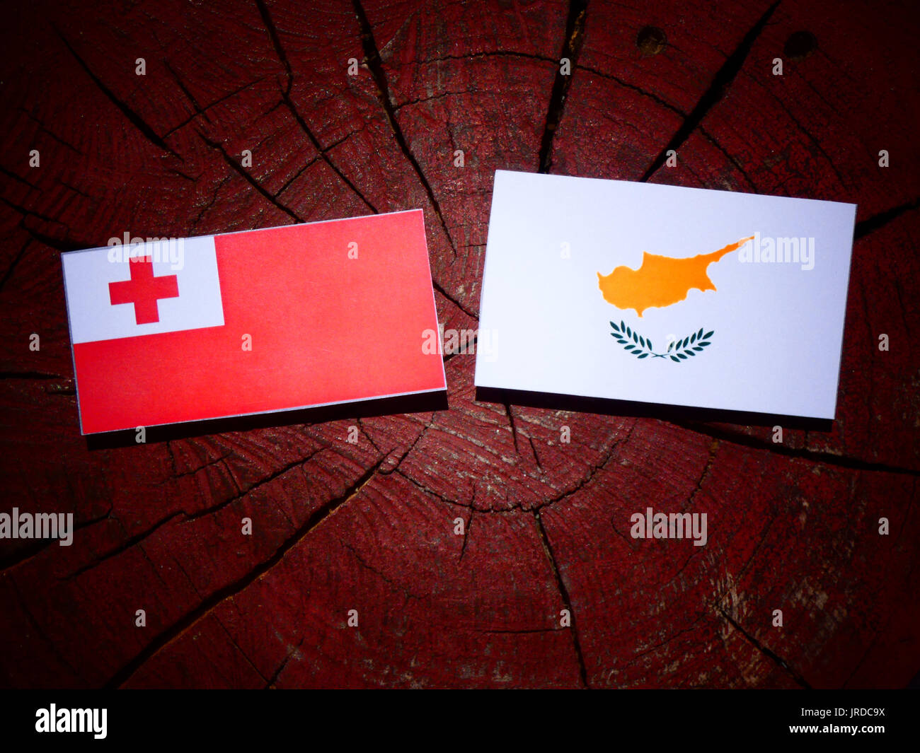 Tongan flag with Cypriot flag on a tree stump isolated Stock Photo - Alamy