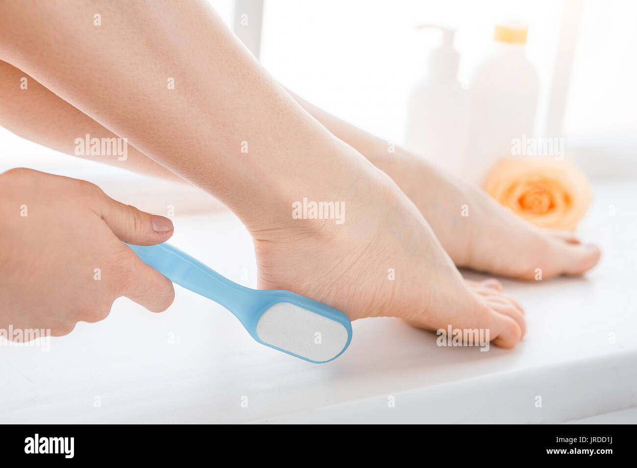 Young female body care at home using pumice Stock Photo - Alamy