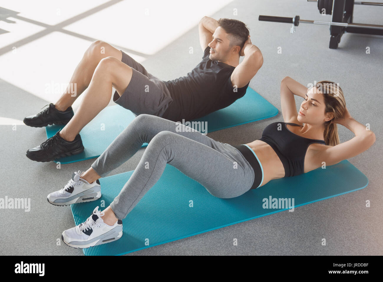 Young man and woman exercise together workout Stock Photo - Alamy
