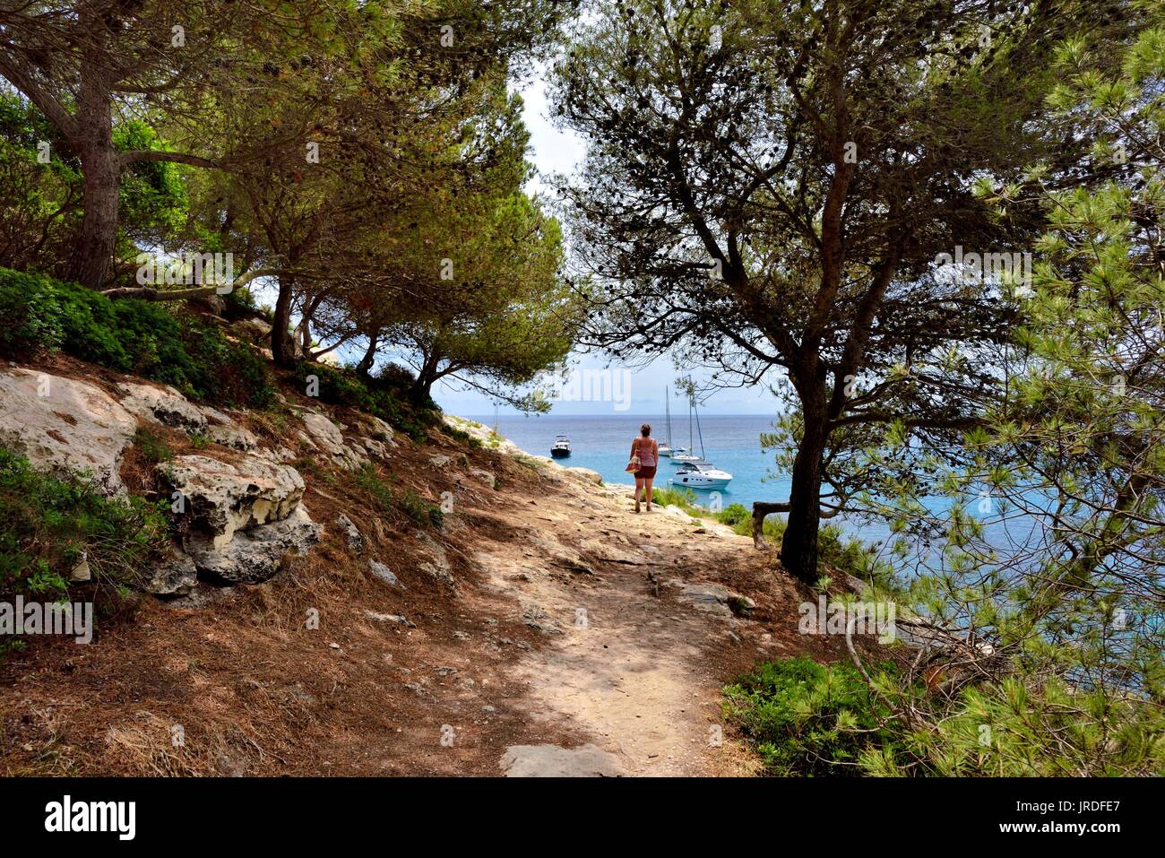 Woman looking out to sea cala galdana menorca minorca Stock Photo - Alamy