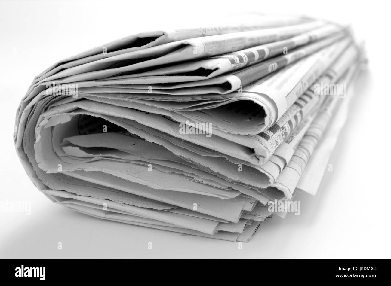 newspaper with news closeup on white background Stock Photo - Alamy