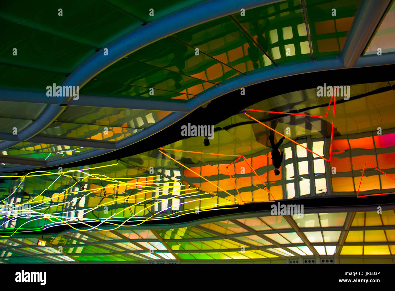 Silhouetted figures on the O'Hare neon walkway are reflections in the ...