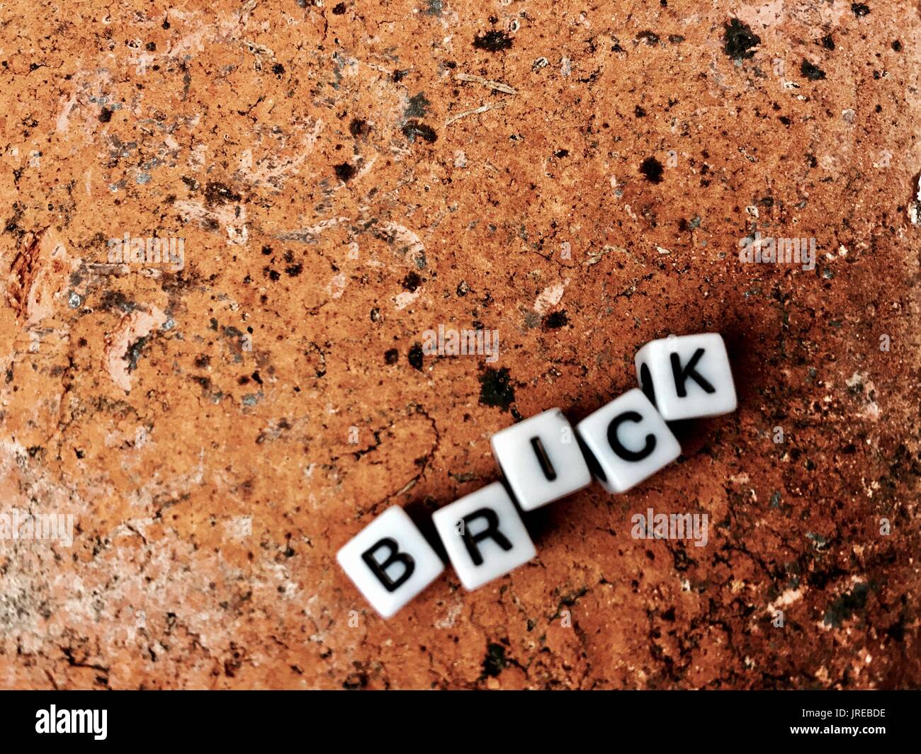 Brick inscription on brown brick. White letters building concept Stock ...