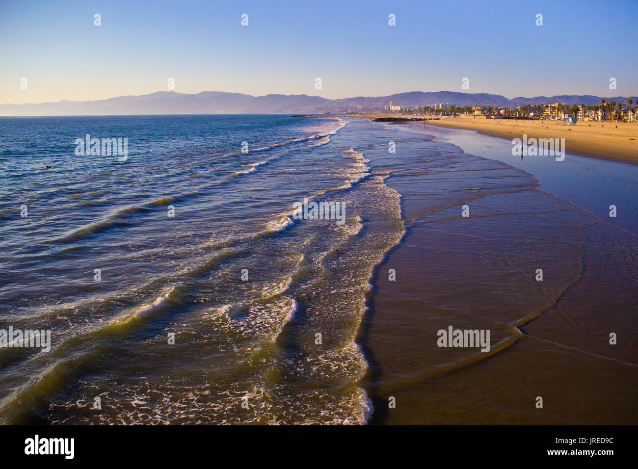 Foamy surf reflects many colors off the beach at Venice, California ...