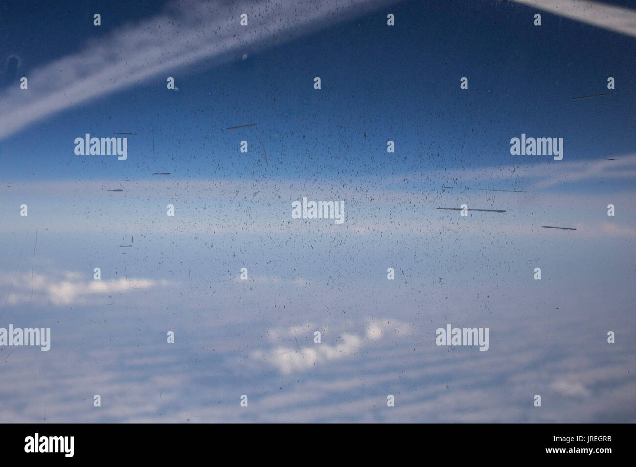 View of sky from dirty aeroplane window Stock Photo - Alamy