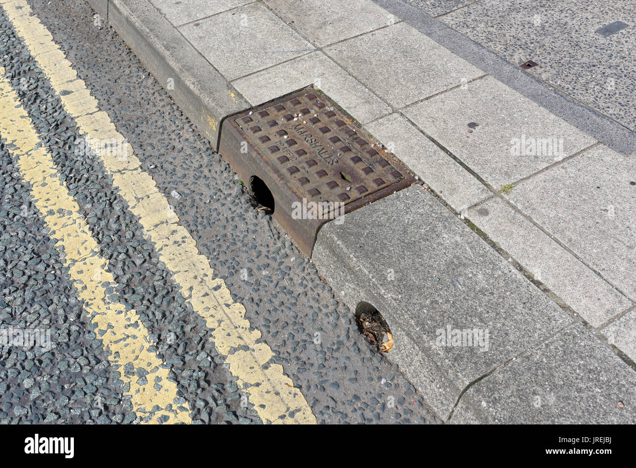 Linear drainage system cast iron access cover and double yellow lines ...