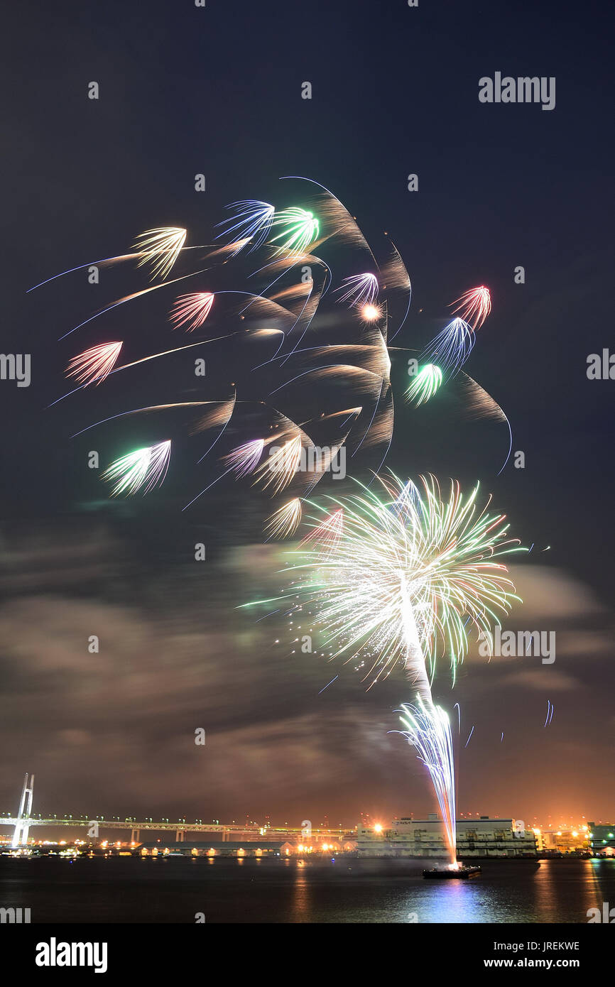 Urban landscape of Yokohama in Japan during summer fireworks. Fireworks ...