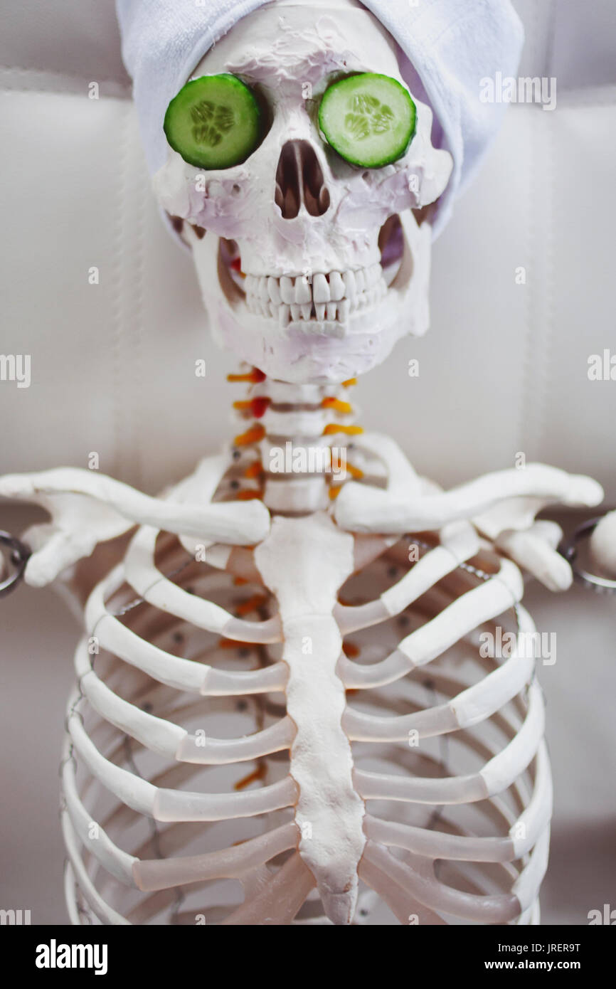 Skeleton in Spa salon with towel on her head and mask on her face ...