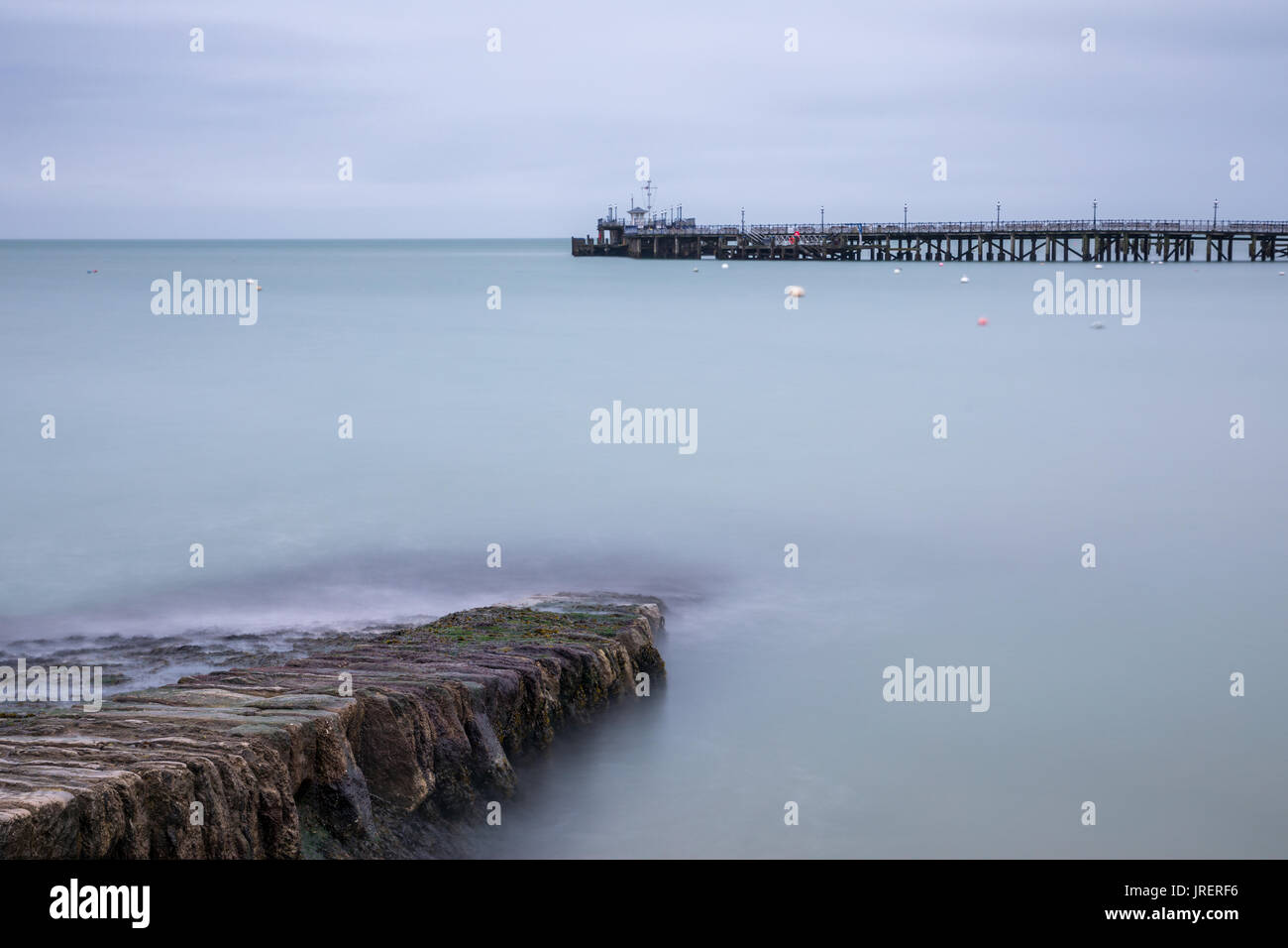 Slipway looking over to wooden pier in Swanage Stock Photo - Alamy