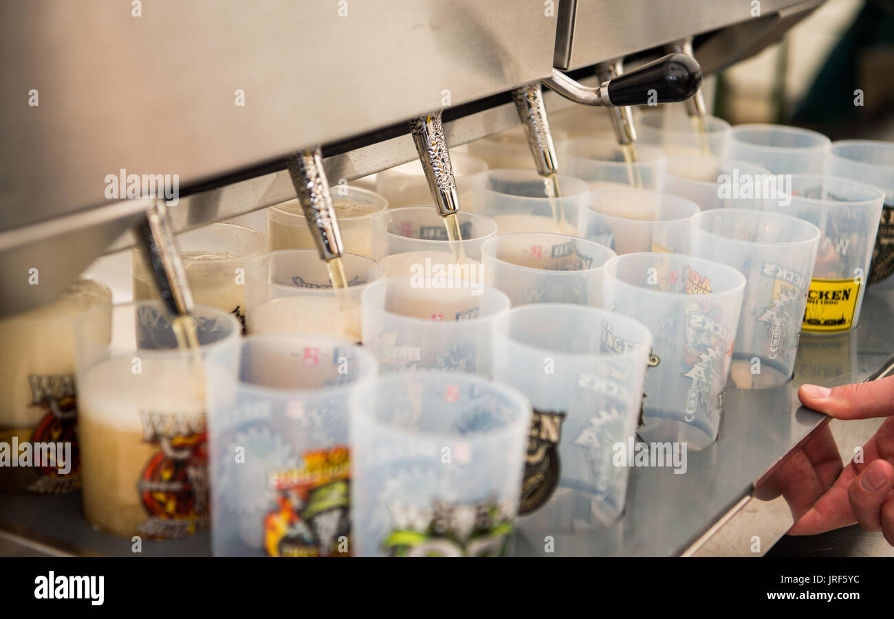 Beer glasses being filled in a filling station at the grounds of the ...