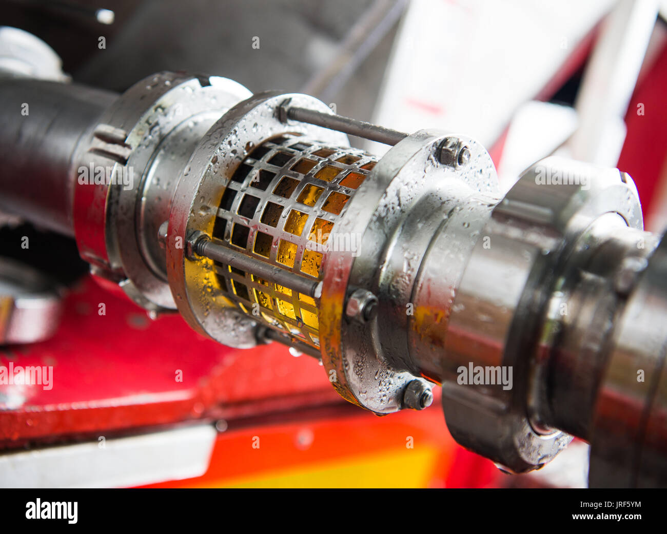 Beer flows through the viewing panel of a beer pipe at a filling ...