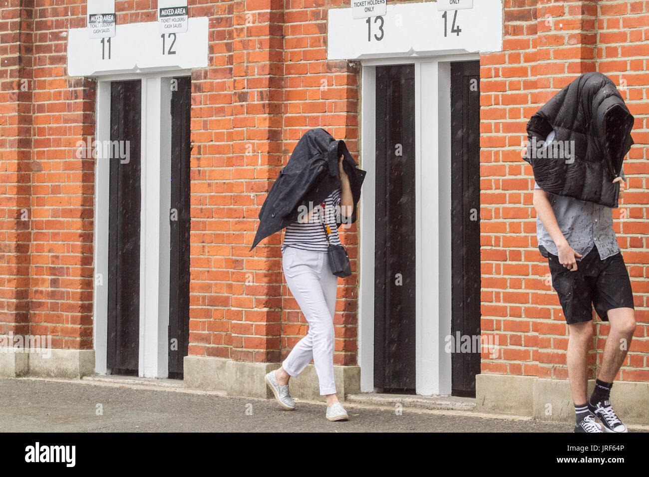 London, UK. 5th Aug, 2017. Football fans are caught in a downpour as ...