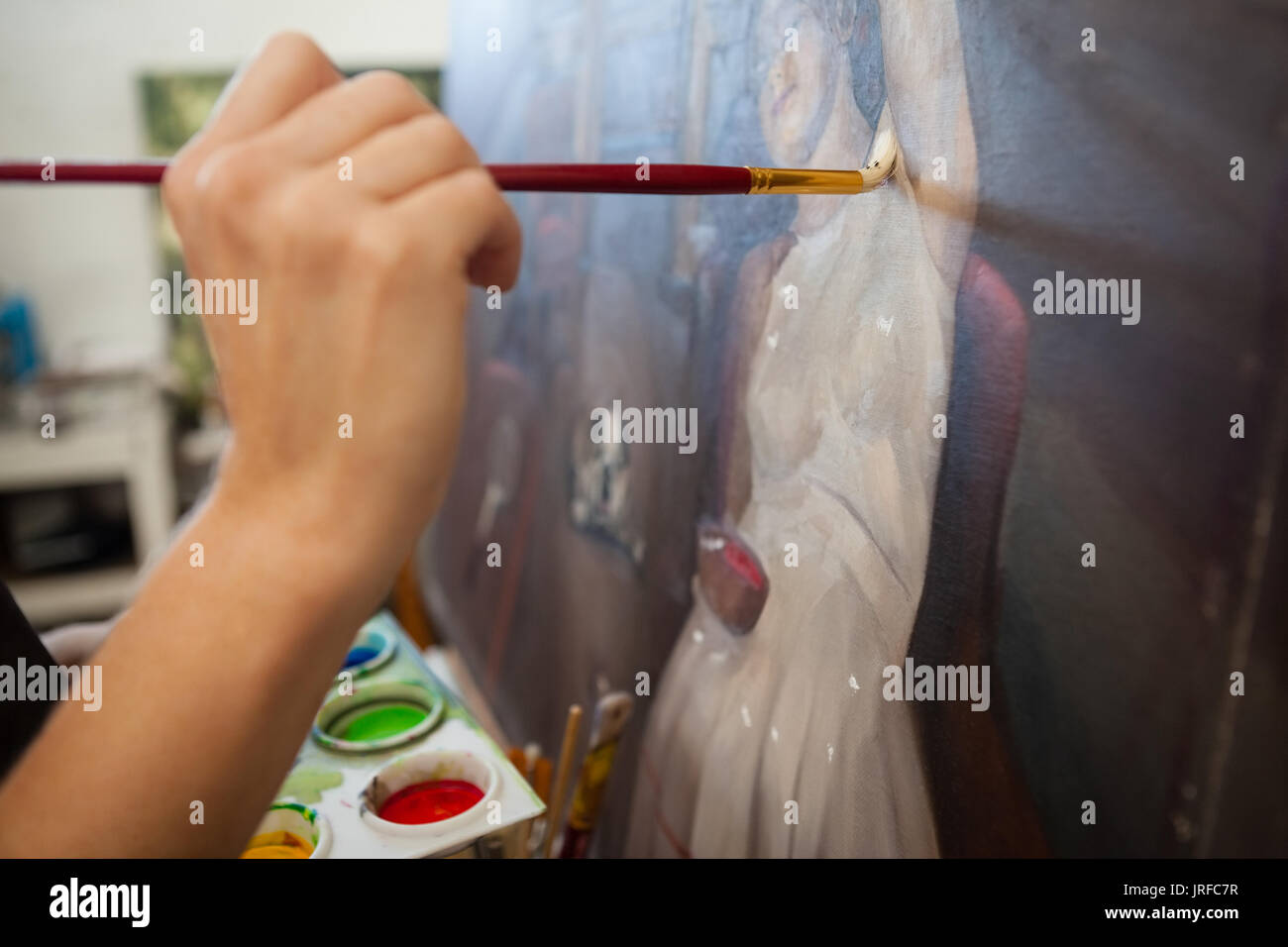 Mid-section of woman painting on canvas in drawing class Stock Photo ...