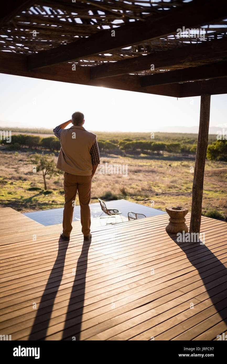 Rear view of man looking at distance Stock Photo - Alamy