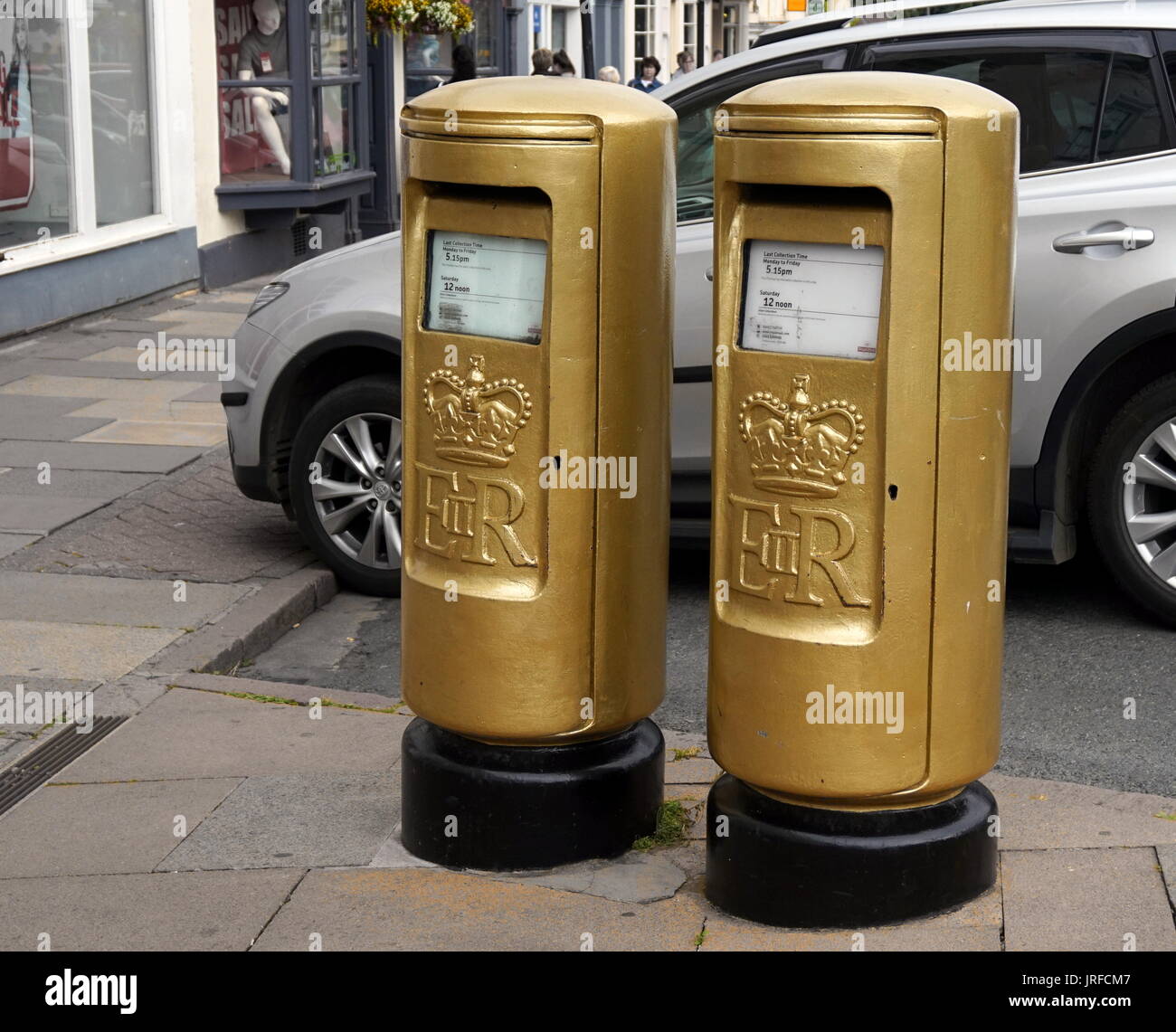 Bridge Street, Stratford-upon-Avon, UK - July 21 2017: Two gold British pillar boxes or post ...