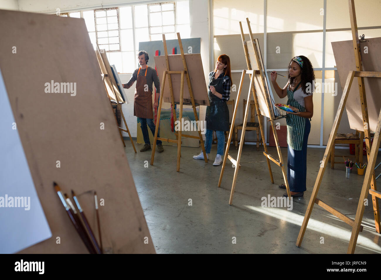 Adult students painting in art class Stock Photo - Alamy