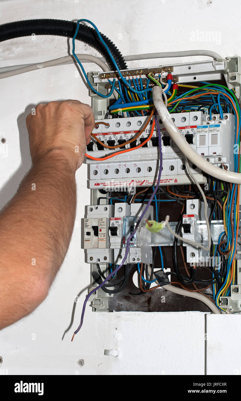 Electrician work connecting cables at switchbox Stock Photo - Alamy