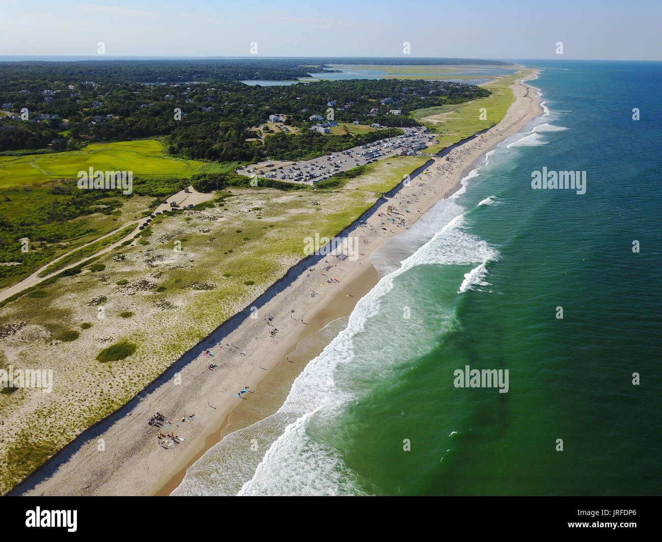 Waves from the Atlantic Ocean wash onto a scenic beach on Cape Cod ...