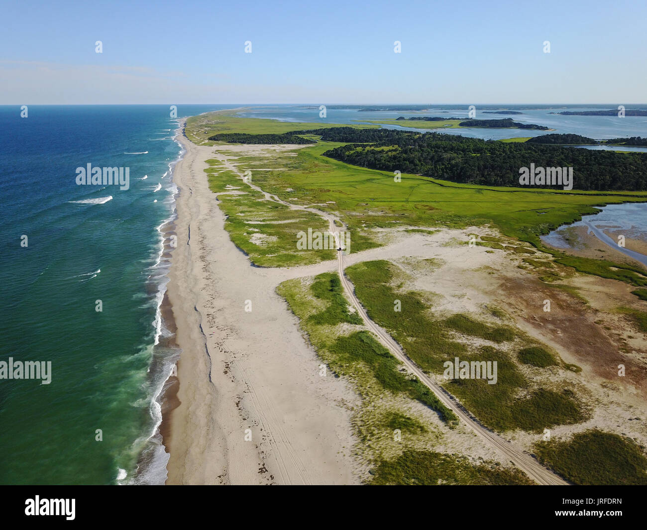 Waves from the Atlantic Ocean wash onto a scenic beach on Cape Cod ...