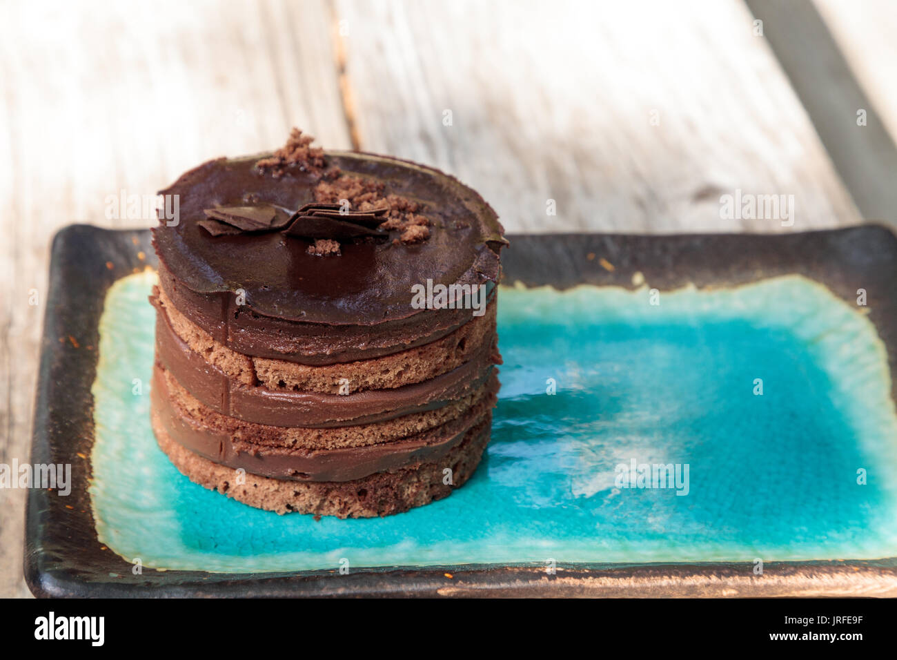 Creamy chocolate mousse layered cake with rich fudge icing Stock Photo ...