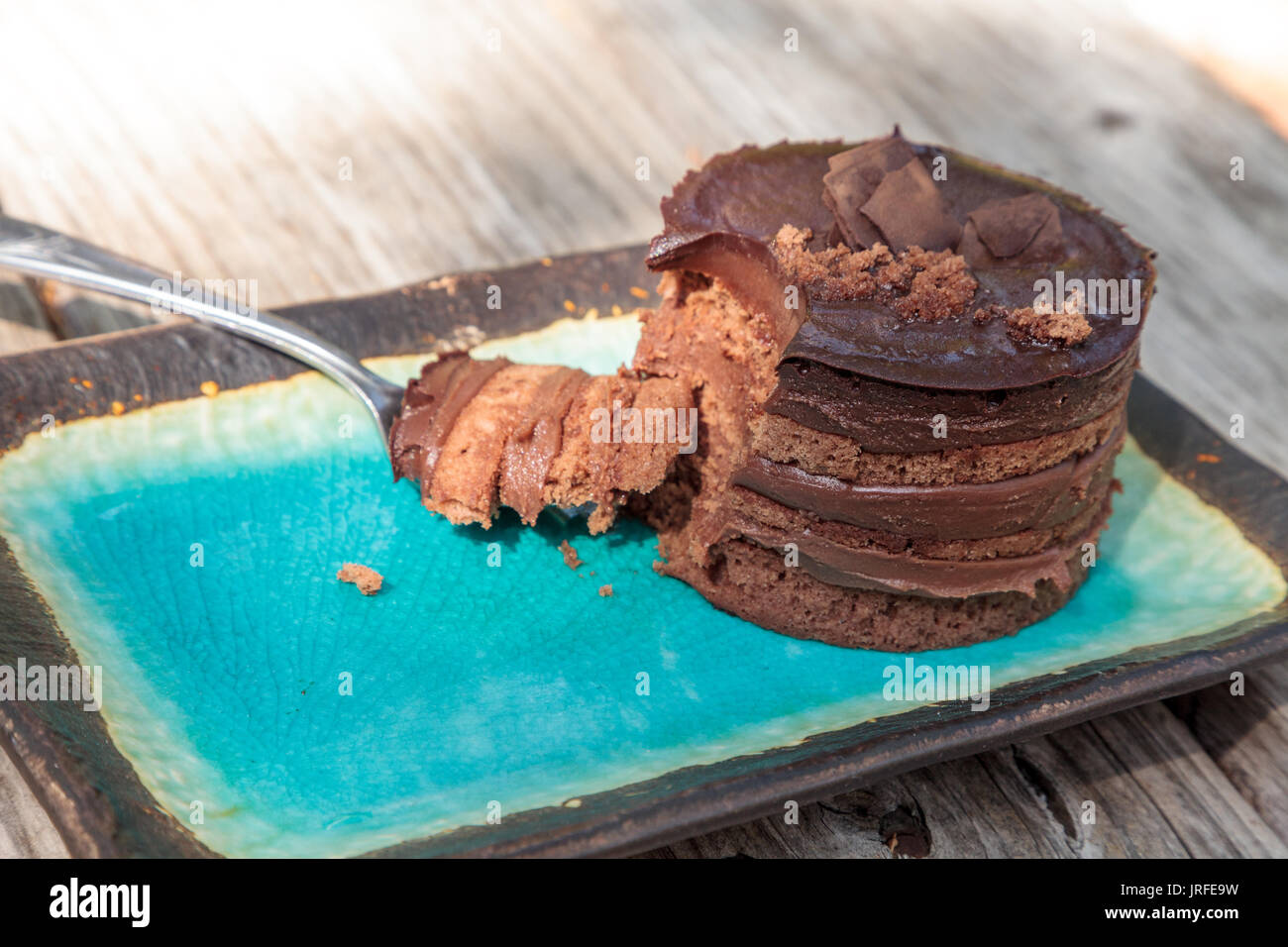 Creamy chocolate mousse layered cake with rich fudge icing Stock Photo ...