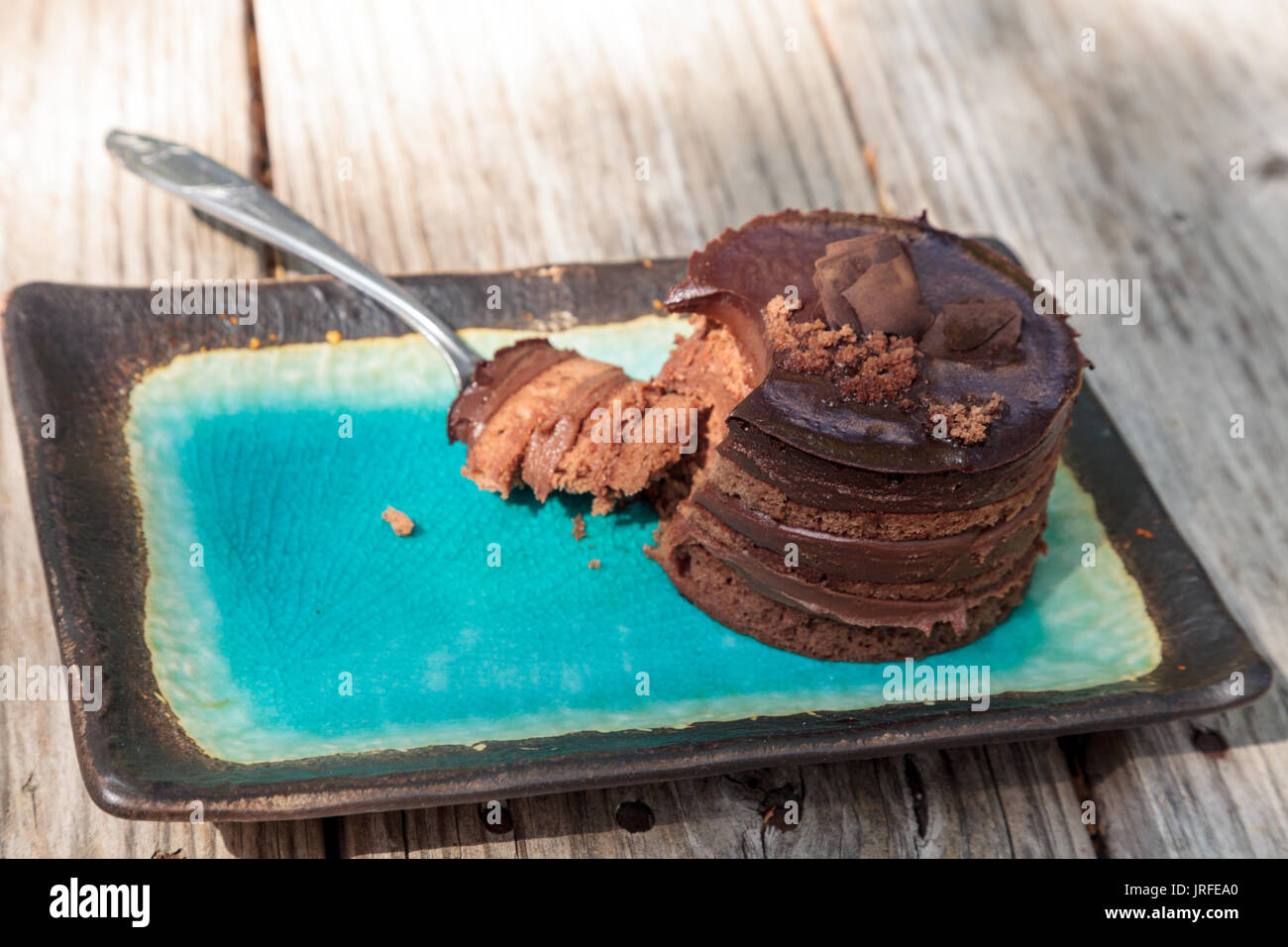 Creamy chocolate mousse layered cake with rich fudge icing Stock Photo ...