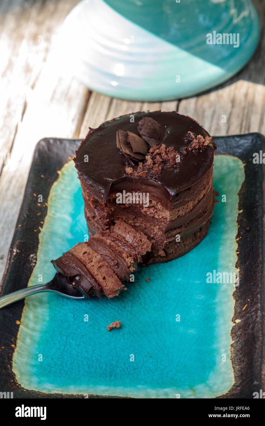 Creamy chocolate mousse layered cake with rich fudge icing Stock Photo ...
