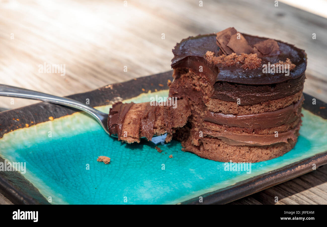 Creamy chocolate mousse layered cake with rich fudge icing Stock Photo ...