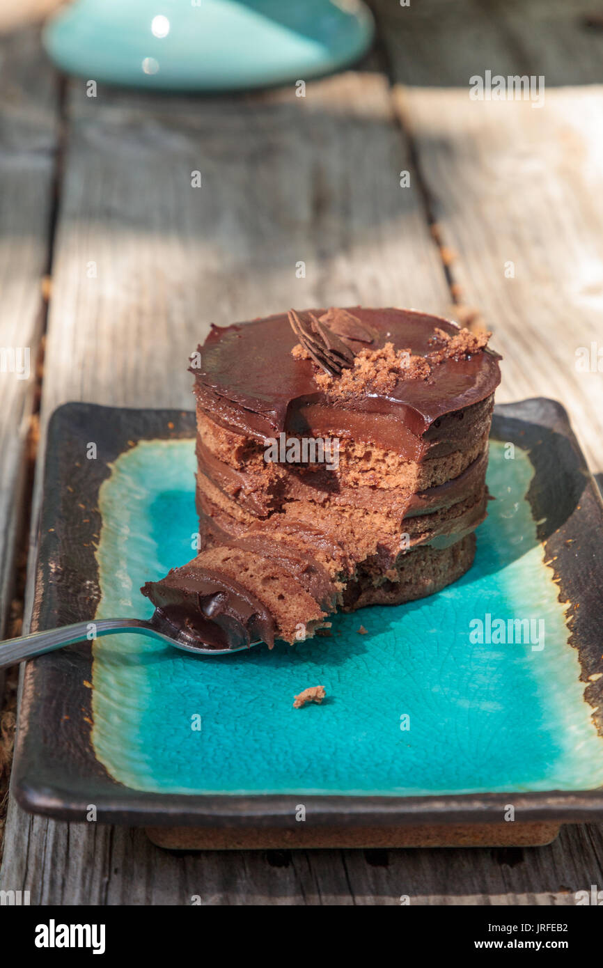 Creamy chocolate mousse layered cake with rich fudge icing Stock Photo ...