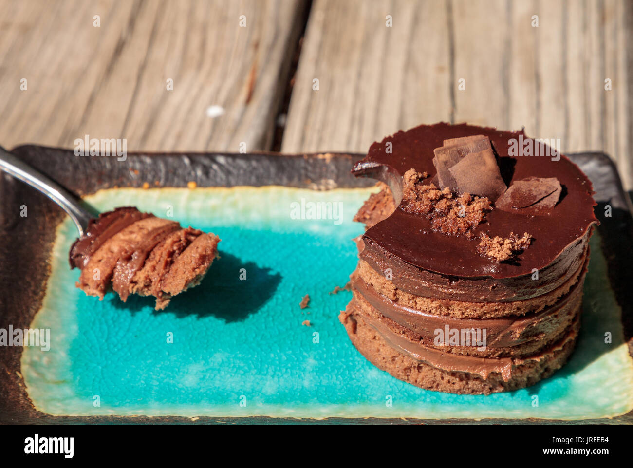 Creamy chocolate mousse layered cake with rich fudge icing Stock Photo ...