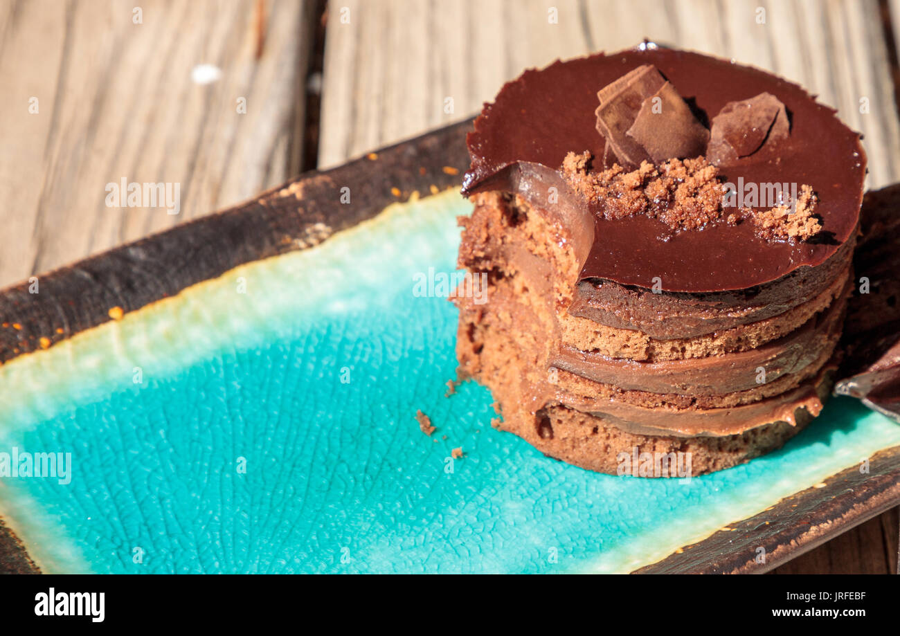 Creamy chocolate mousse layered cake with rich fudge icing Stock Photo ...