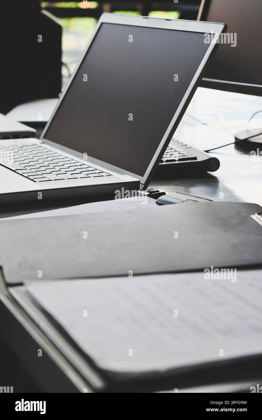 Laptop and papers on desk Stock Photo - Alamy