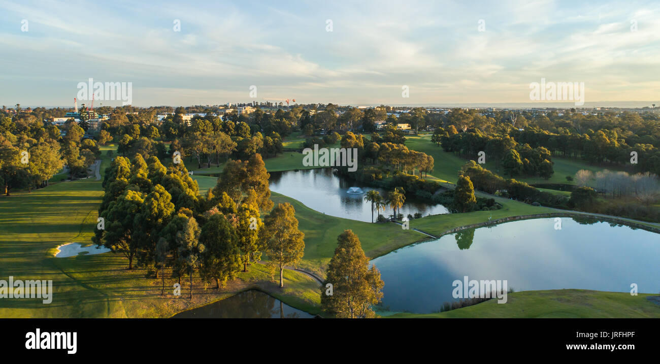 Aerial view of golf course showing fairways, bunkers and dam water ...