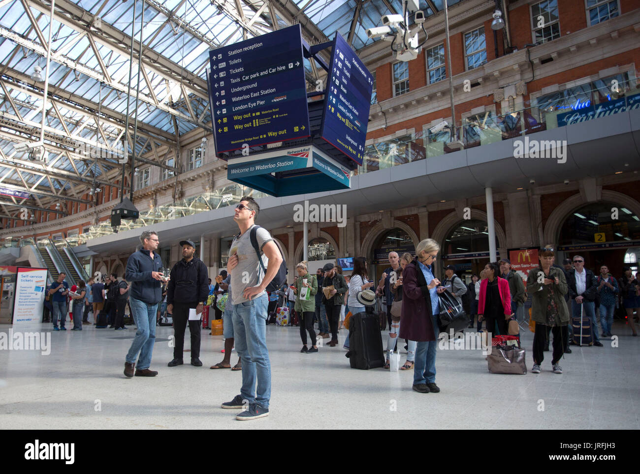 Passengers wait to board their trains as engineering work begins at ...