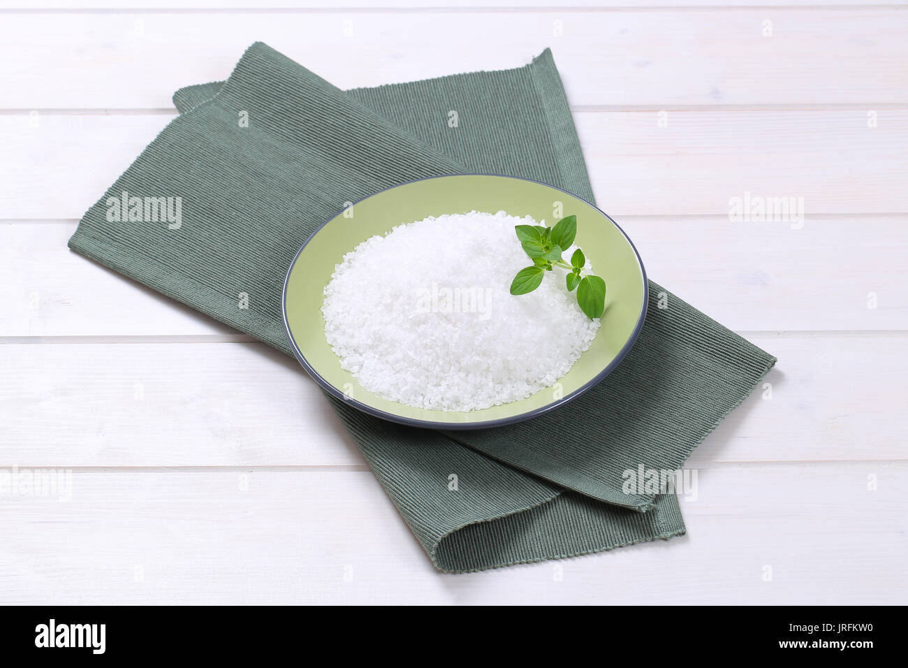 plate of coarse grained sea salt on grey place mat Stock Photo - Alamy
