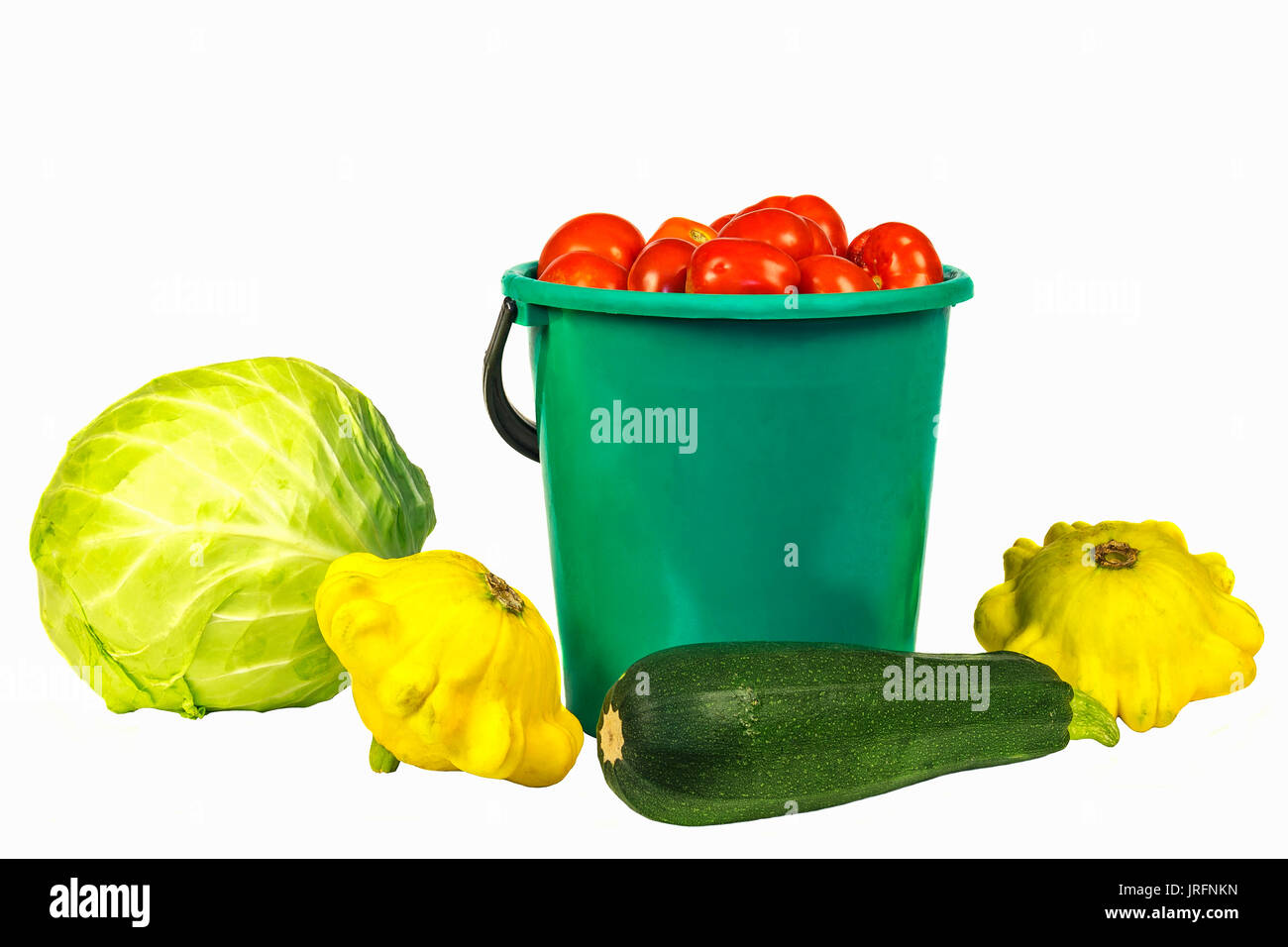 Bucket with tomatoes, cabbage, zucchini and squash on a white ...