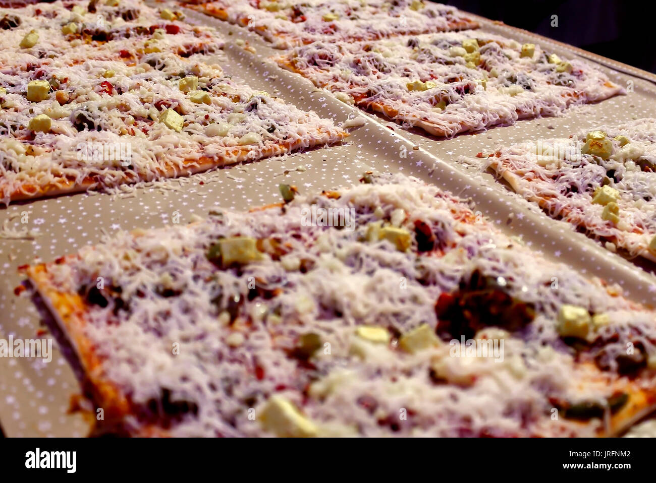 many square pan pizza with cheese are ready to serve on family ...