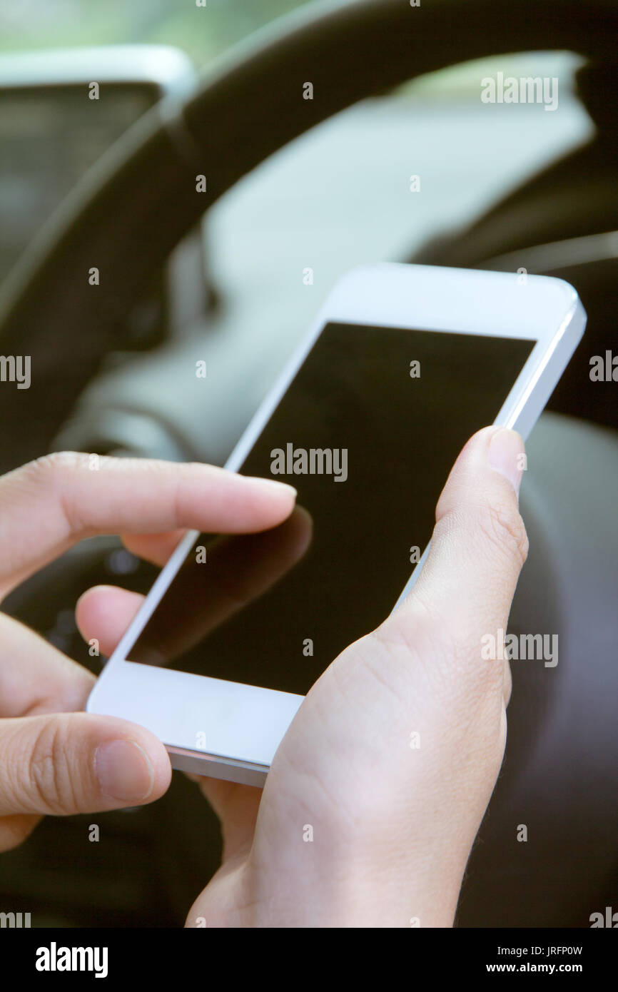 image of using a mobile phone inside of a car Stock Photo - Alamy