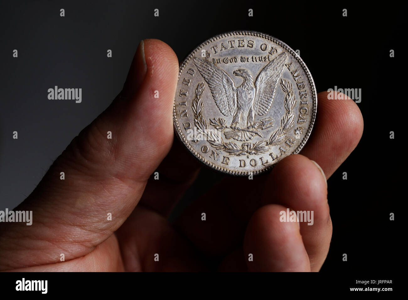 the old silver American dollar of 1878 in hand Stock Photo - Alamy