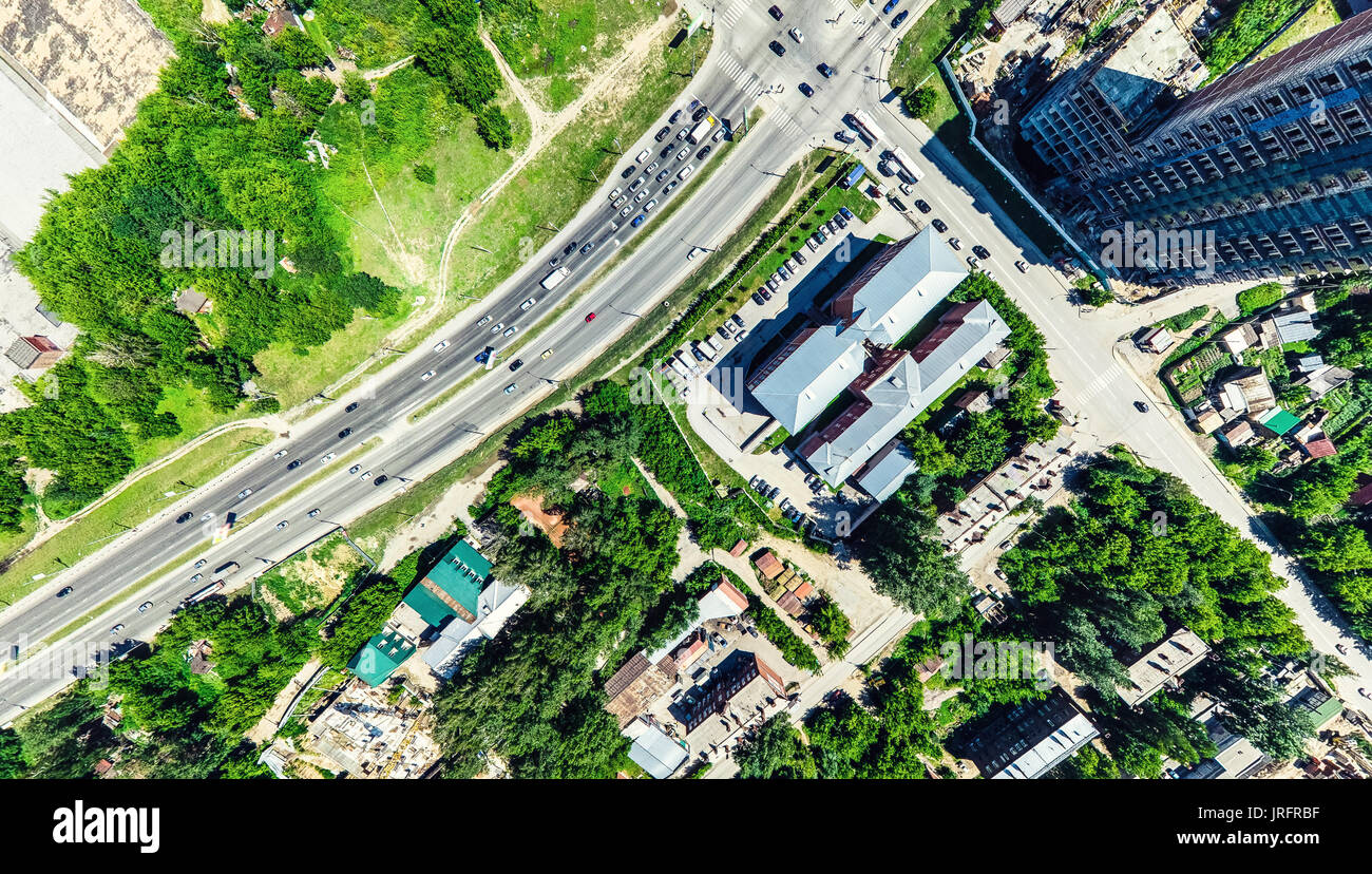 Aerial city view with crossroads and roads, houses, buildings, parks ...