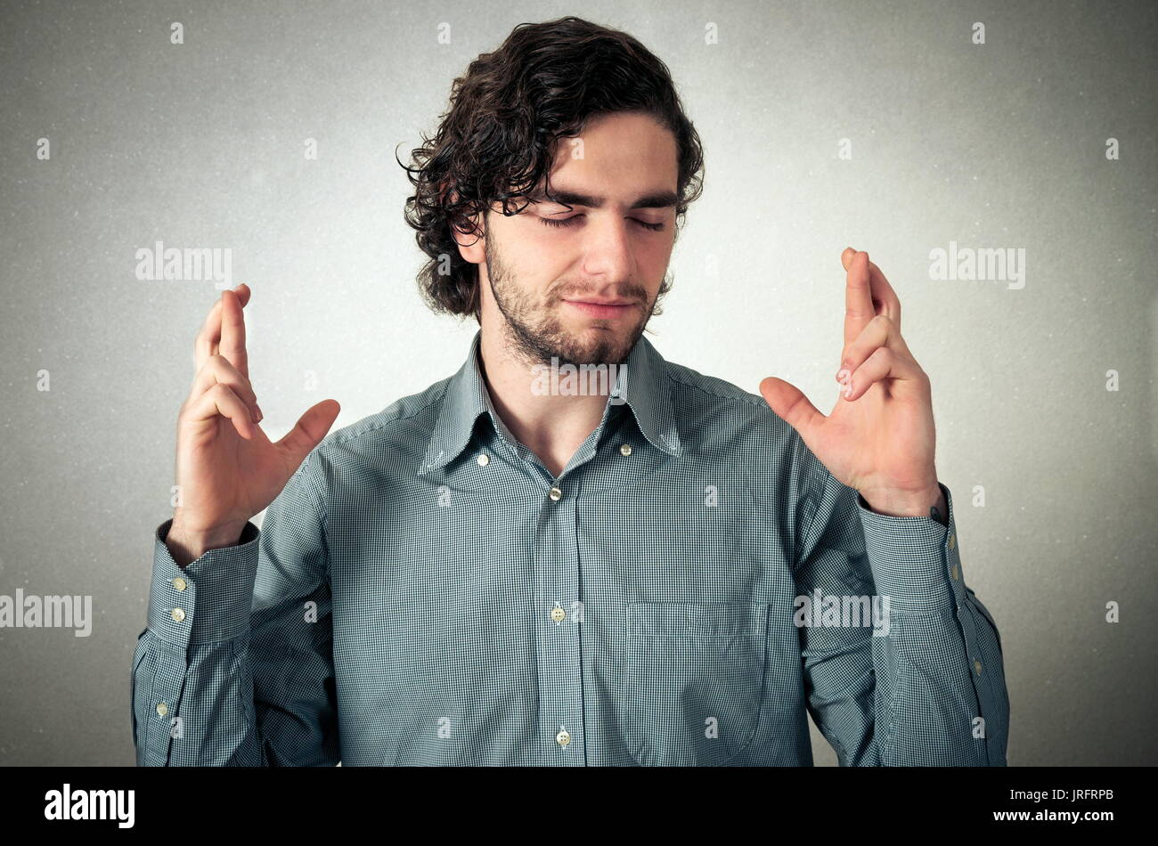 Happy businessman fingers crossed hi-res stock photography and images ...