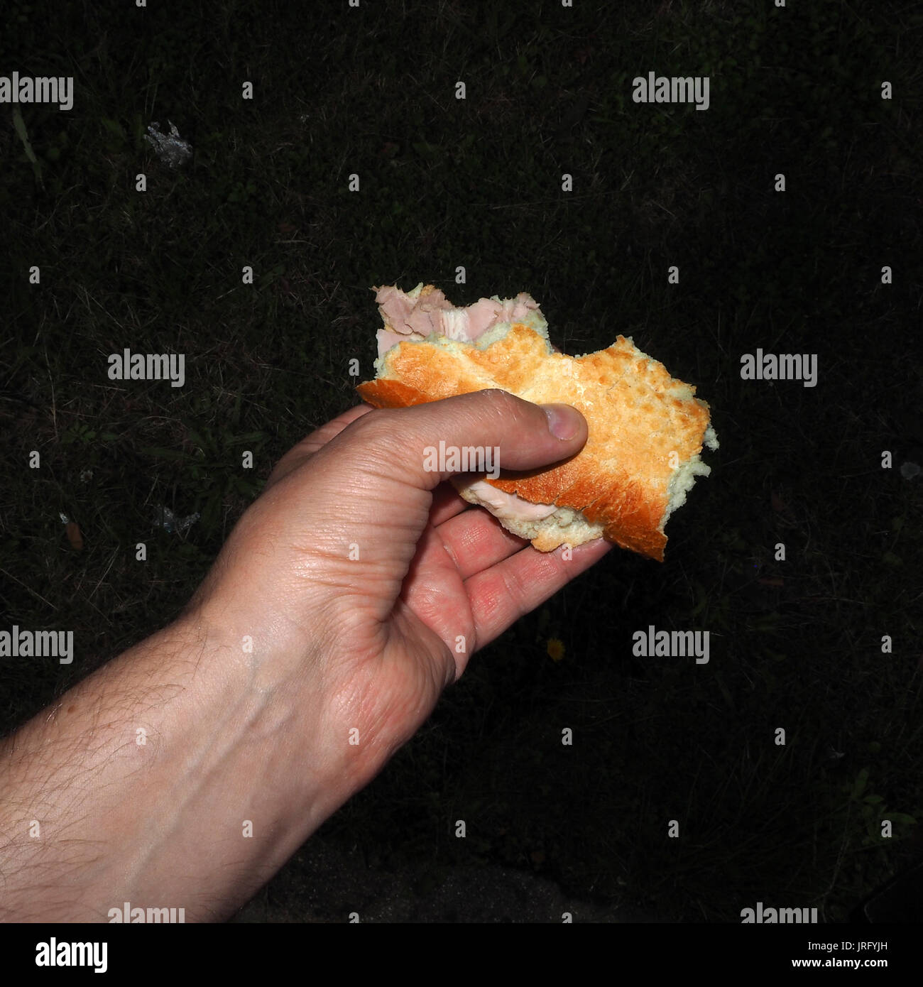 Man holding ham baguette Stock Photo - Alamy
