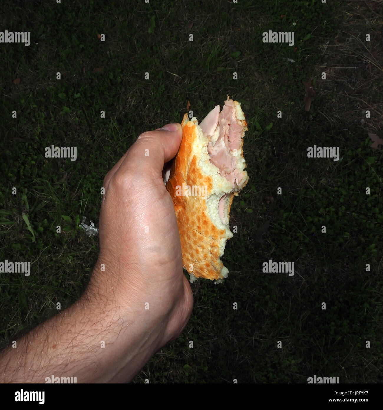 Man holding ham baguette Stock Photo - Alamy